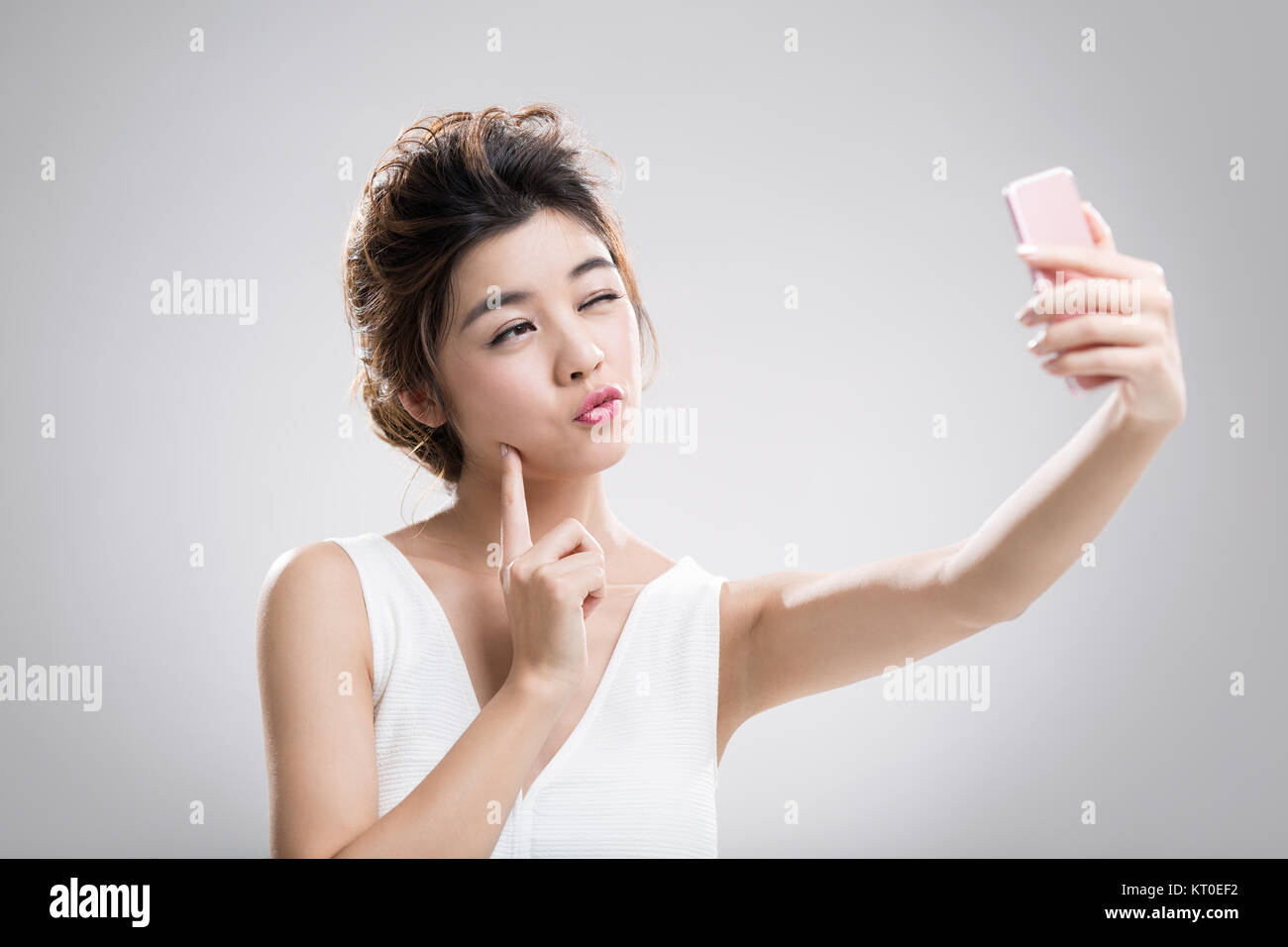 Young woman taking self portrait with smart phone Stock Photo - Alamy