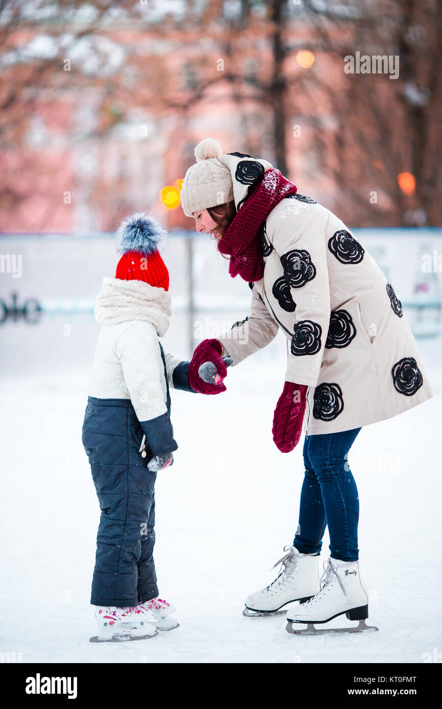 Little adorable girl with her mom skating on ice-rink Stock Photo - Alamy
