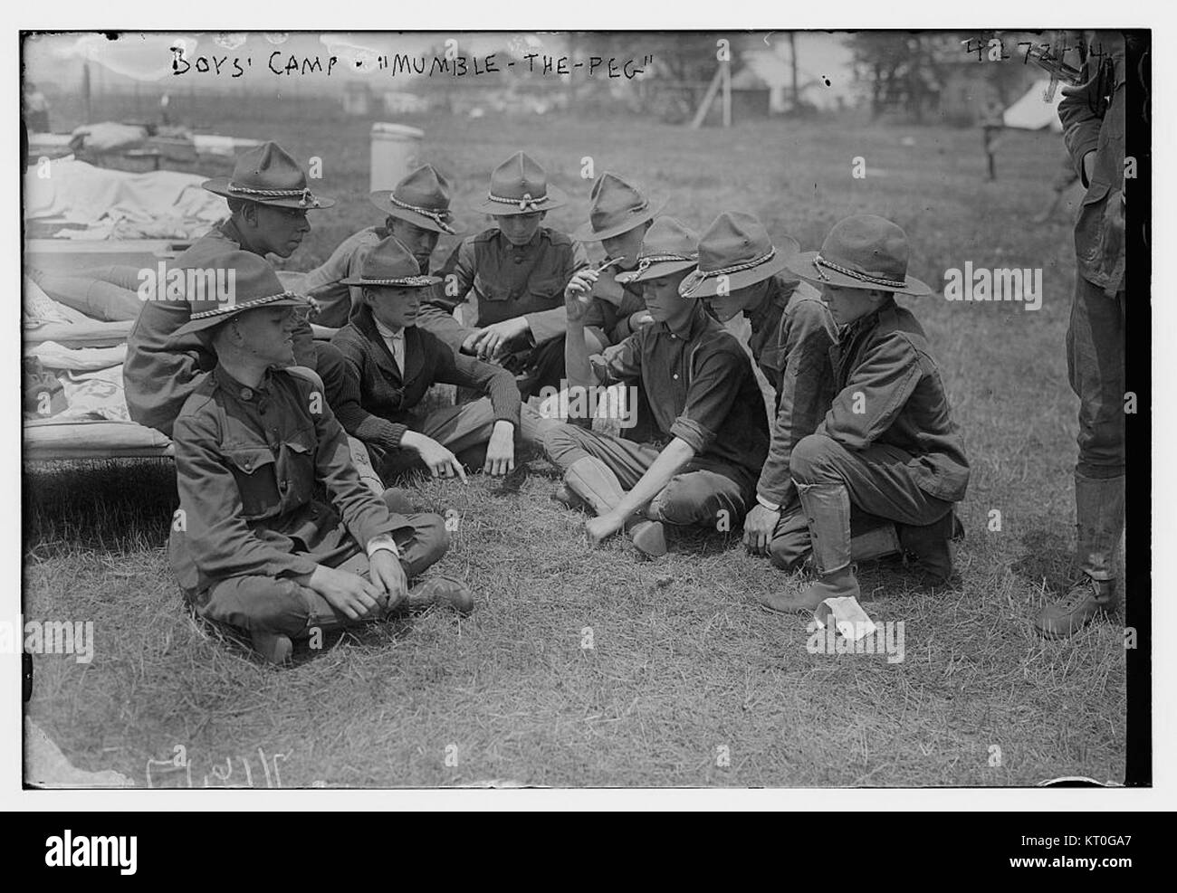 This image depicts a group of boys playing Mumble-the-Peg, a ...