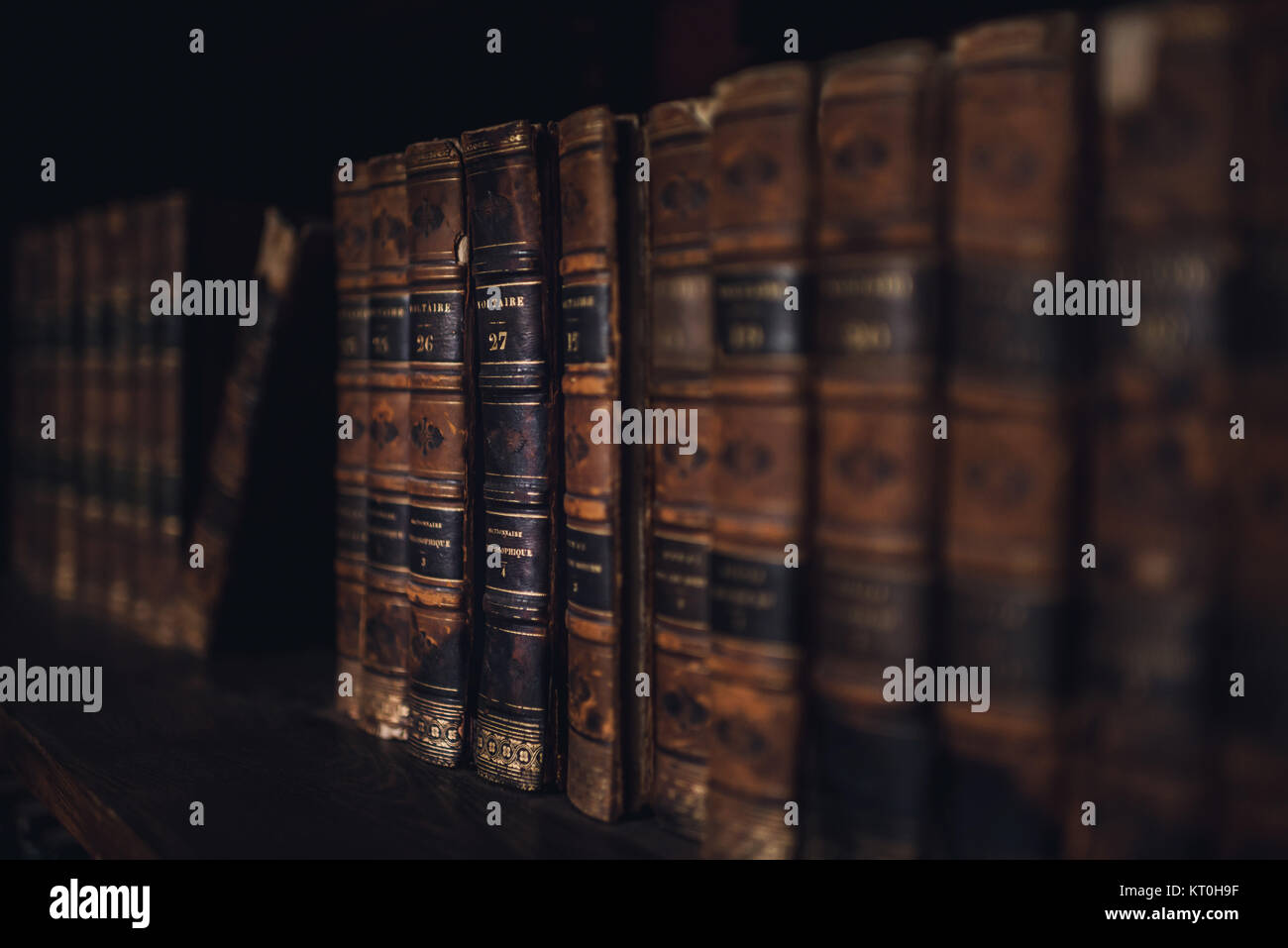 An antique collection of Voltaire books sitting on a bookshelf. Title ...