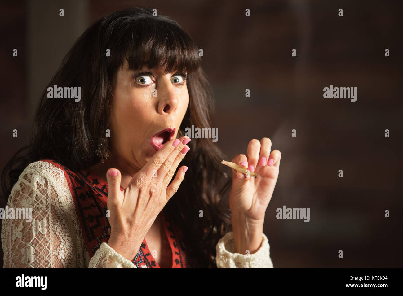 Embarrassed female marijuana smoker coughing Stock Photo - Alamy