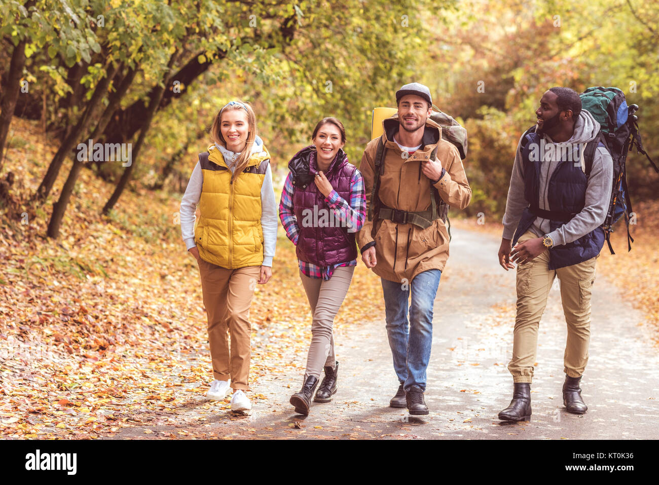 Happy young backpackers in forest Stock Photo - Alamy