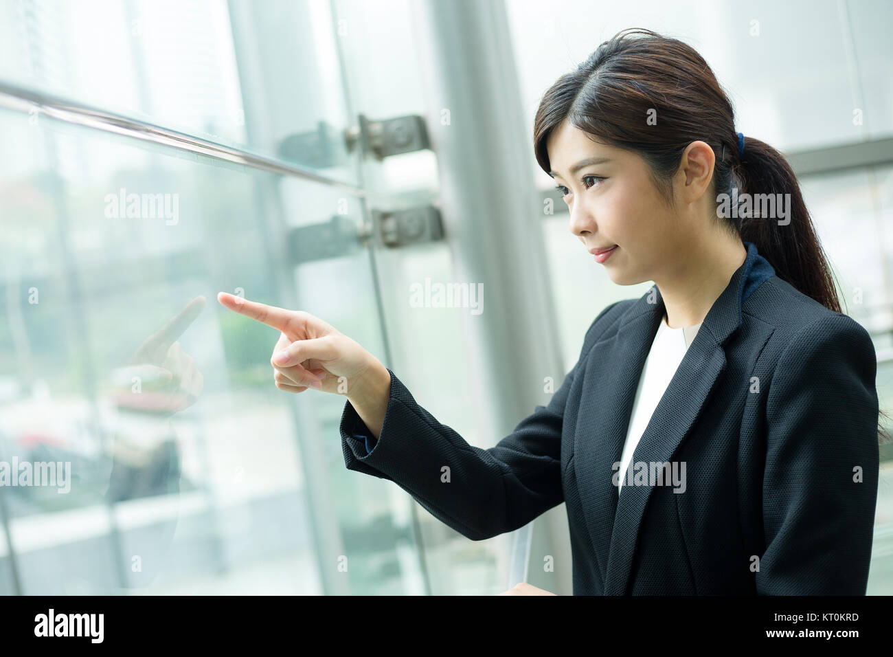 Business woman with finger pointing on window Stock Photo - Alamy