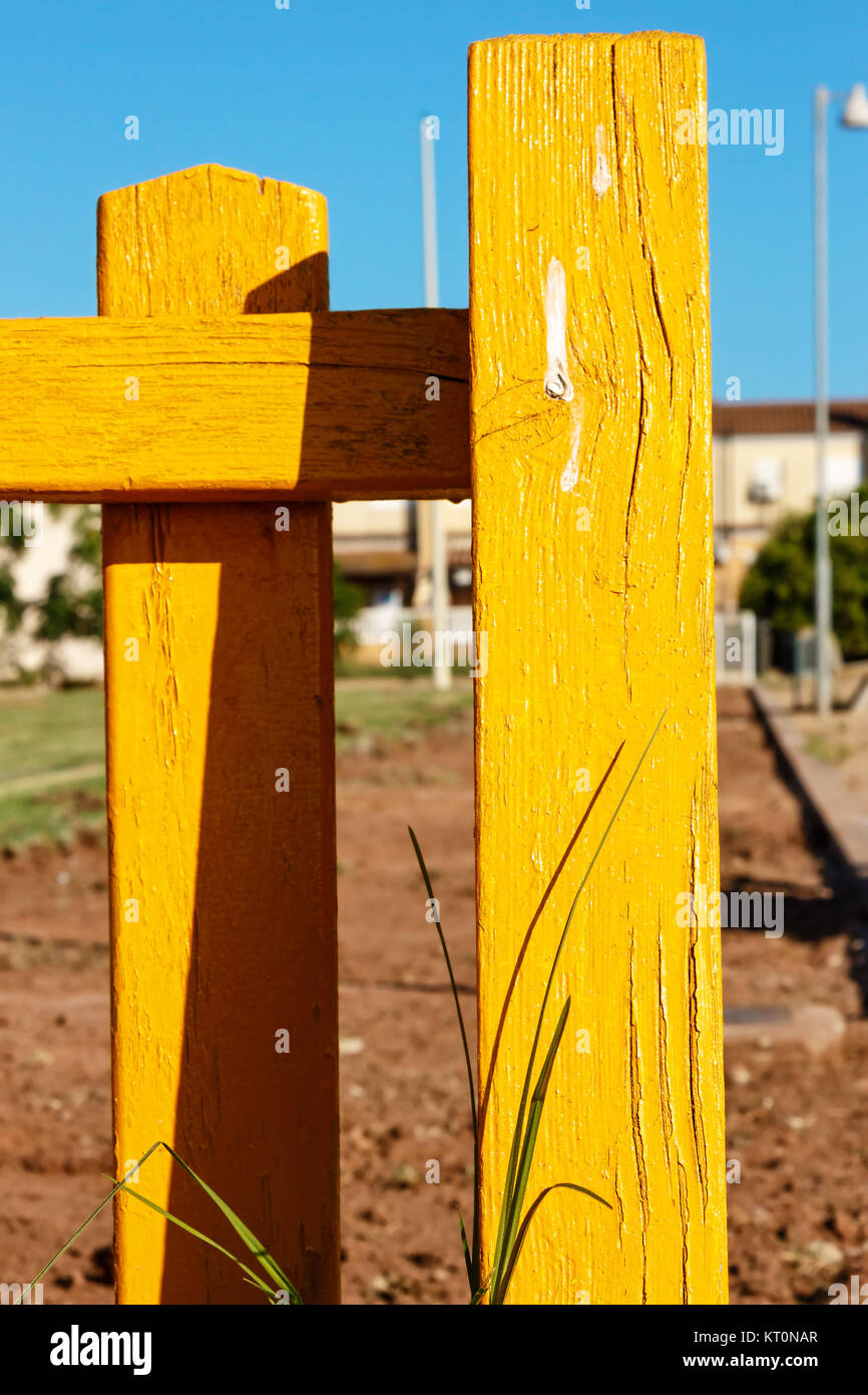 Yellow fence post Stock Photo - Alamy