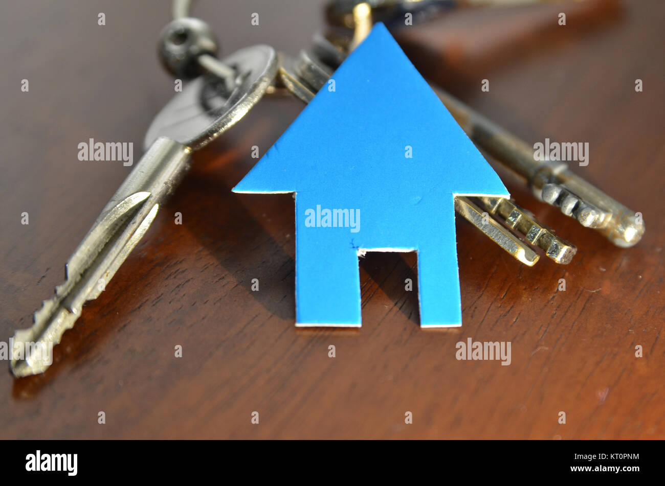 Silver key with blue house figure Stock Photo - Alamy