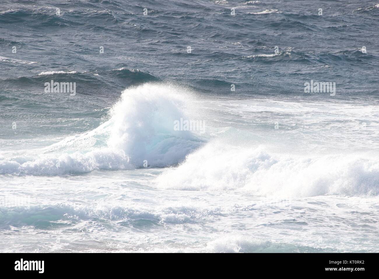 big waves in the ocean causing spray and white surf Stock Photo - Alamy