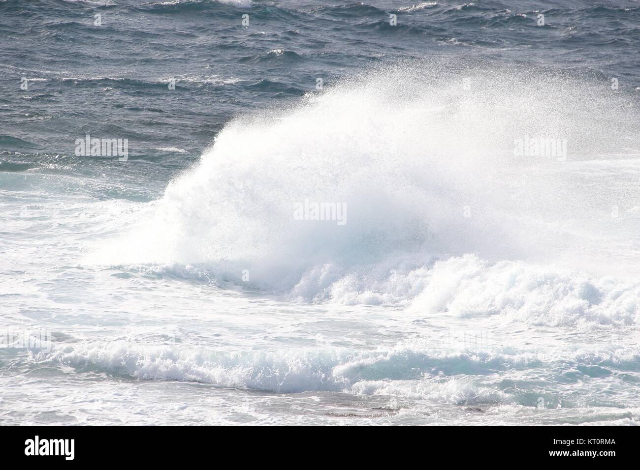 big waves in the ocean causing spray and white surf Stock Photo - Alamy