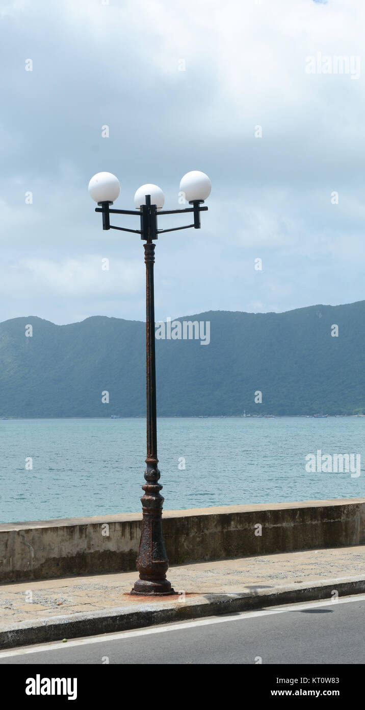 Lamp post on rural road at sunny day with seascape background Stock ...