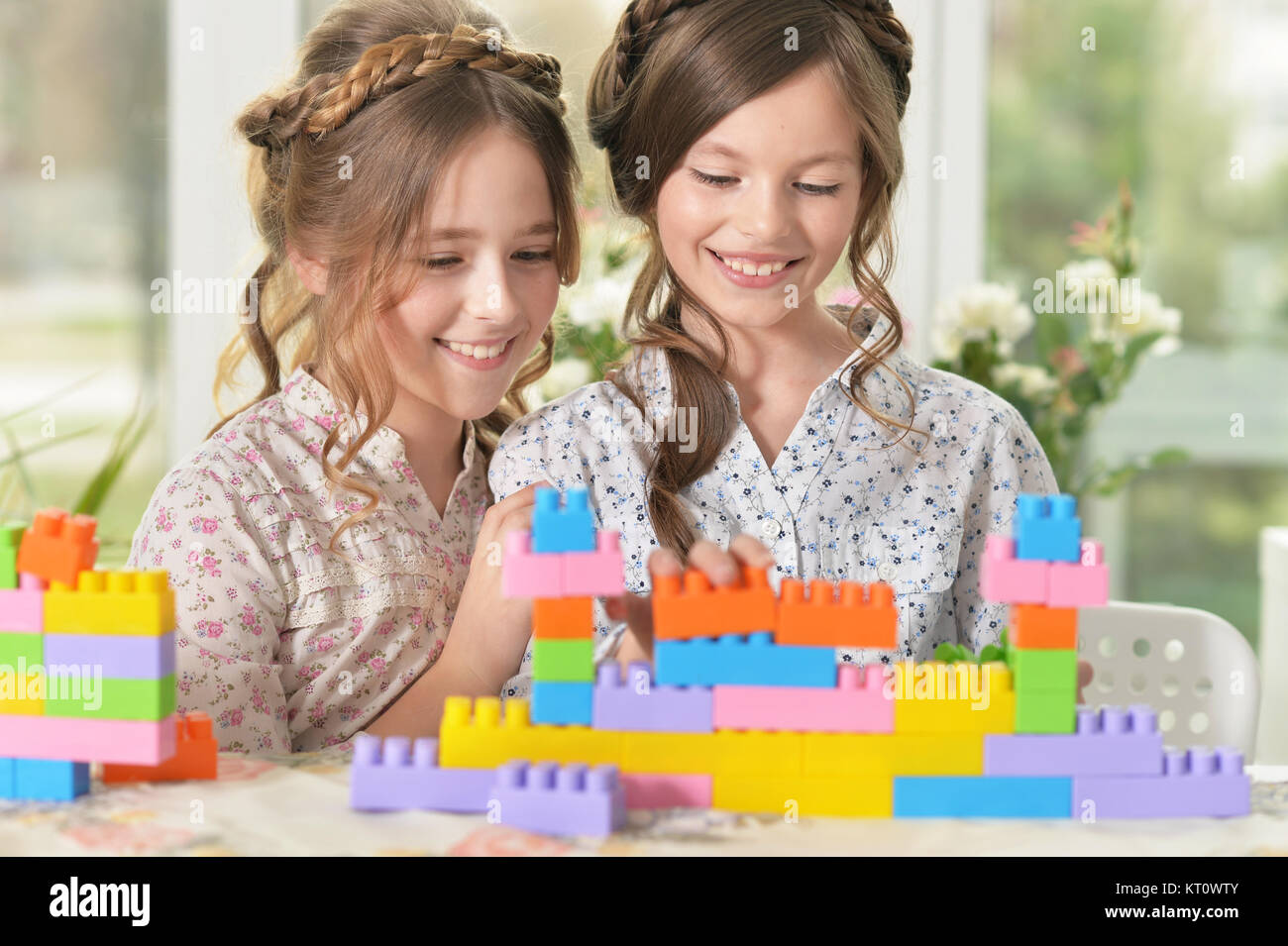 girls playing with colorful blocks Stock Photo - Alamy
