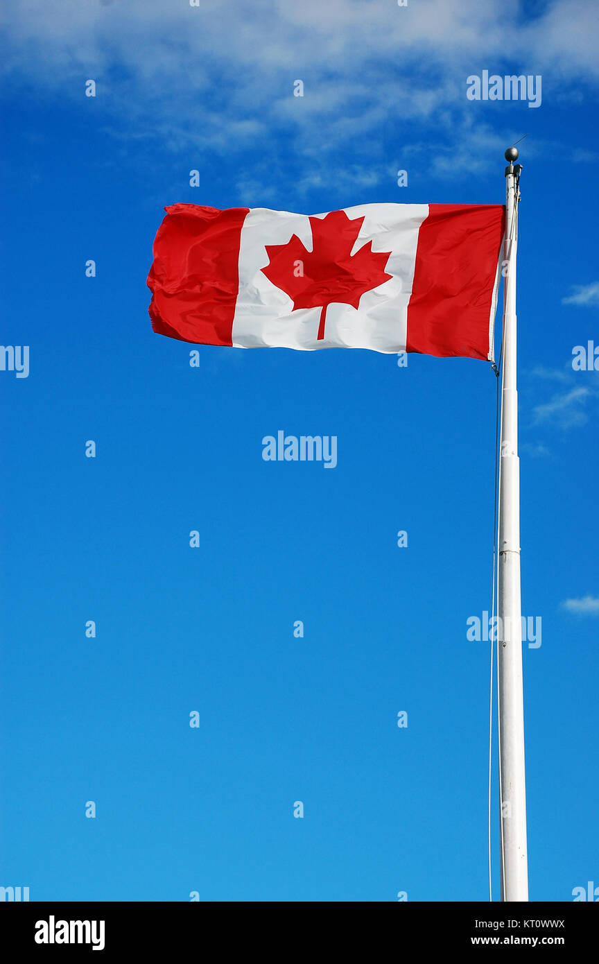 Canadian flag in blue sky Stock Photo - Alamy