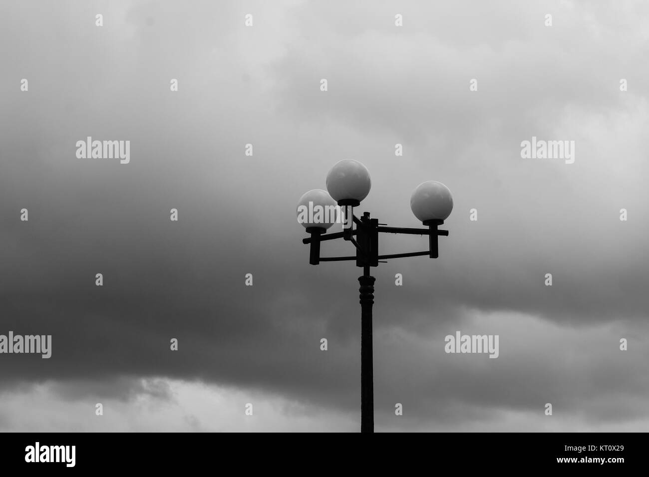 Lamp post under gray sky at rainy day. Close up Stock Photo - Alamy