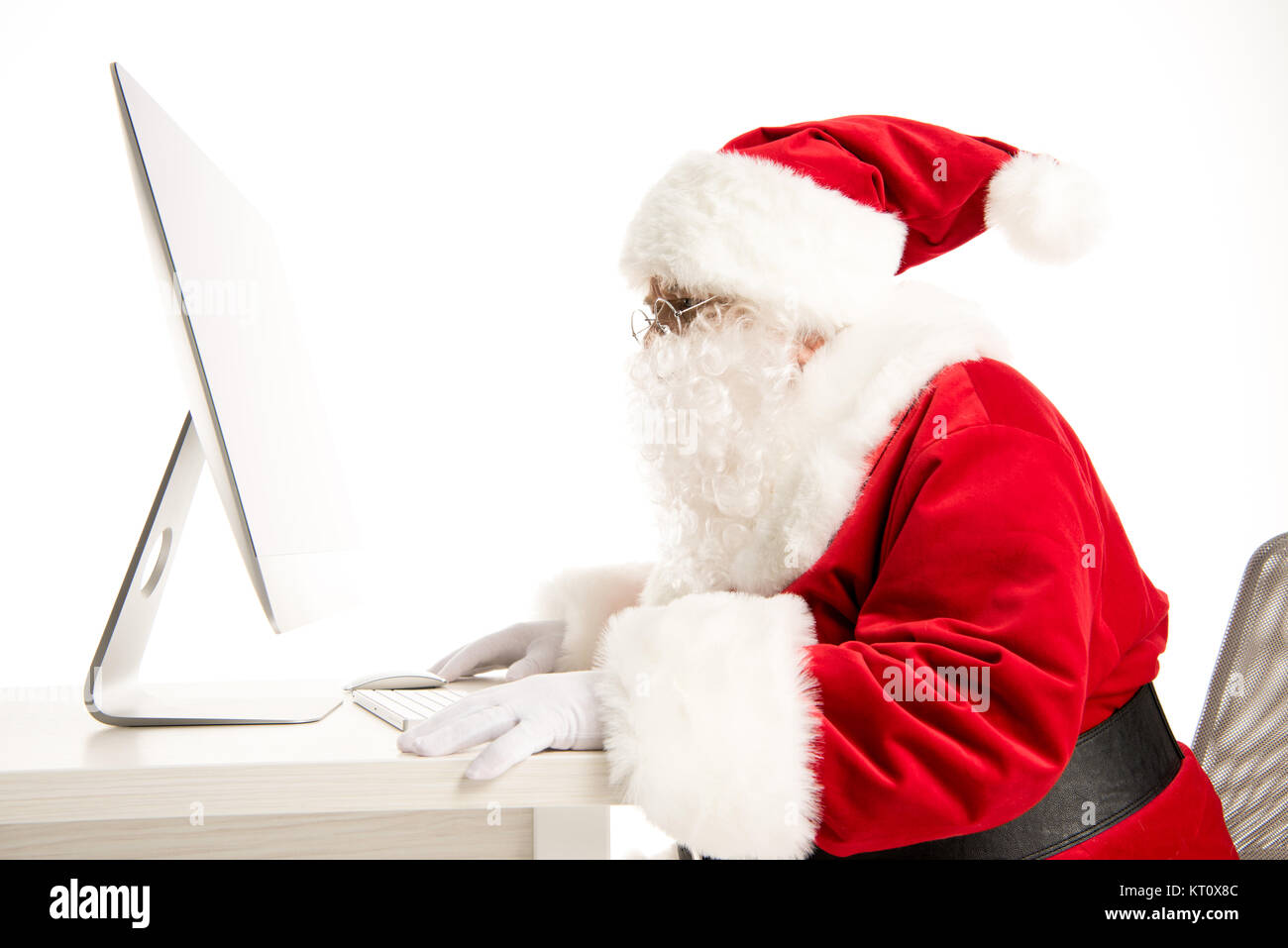 Santa Claus looking at computer Stock Photo - Alamy