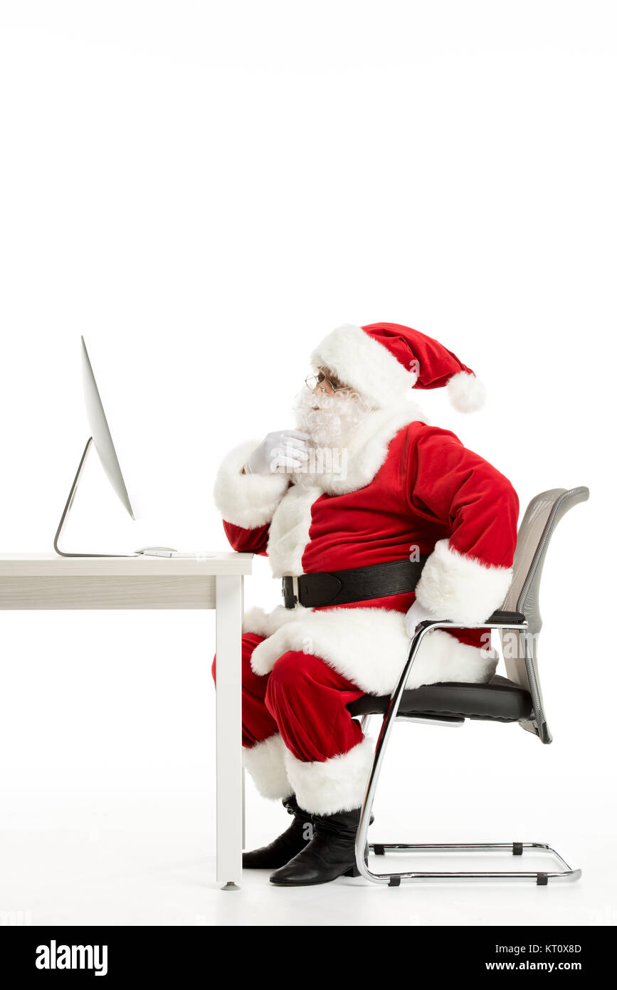 Thoughtful Santa Claus looking at computer Stock Photo - Alamy