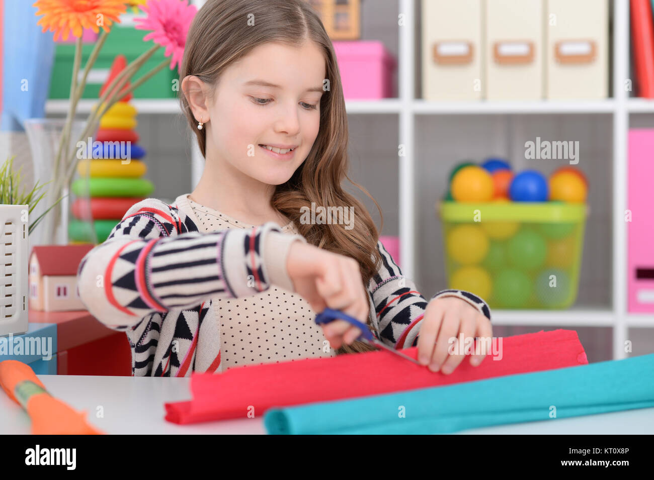 Girl snipping paper Stock Photo - Alamy