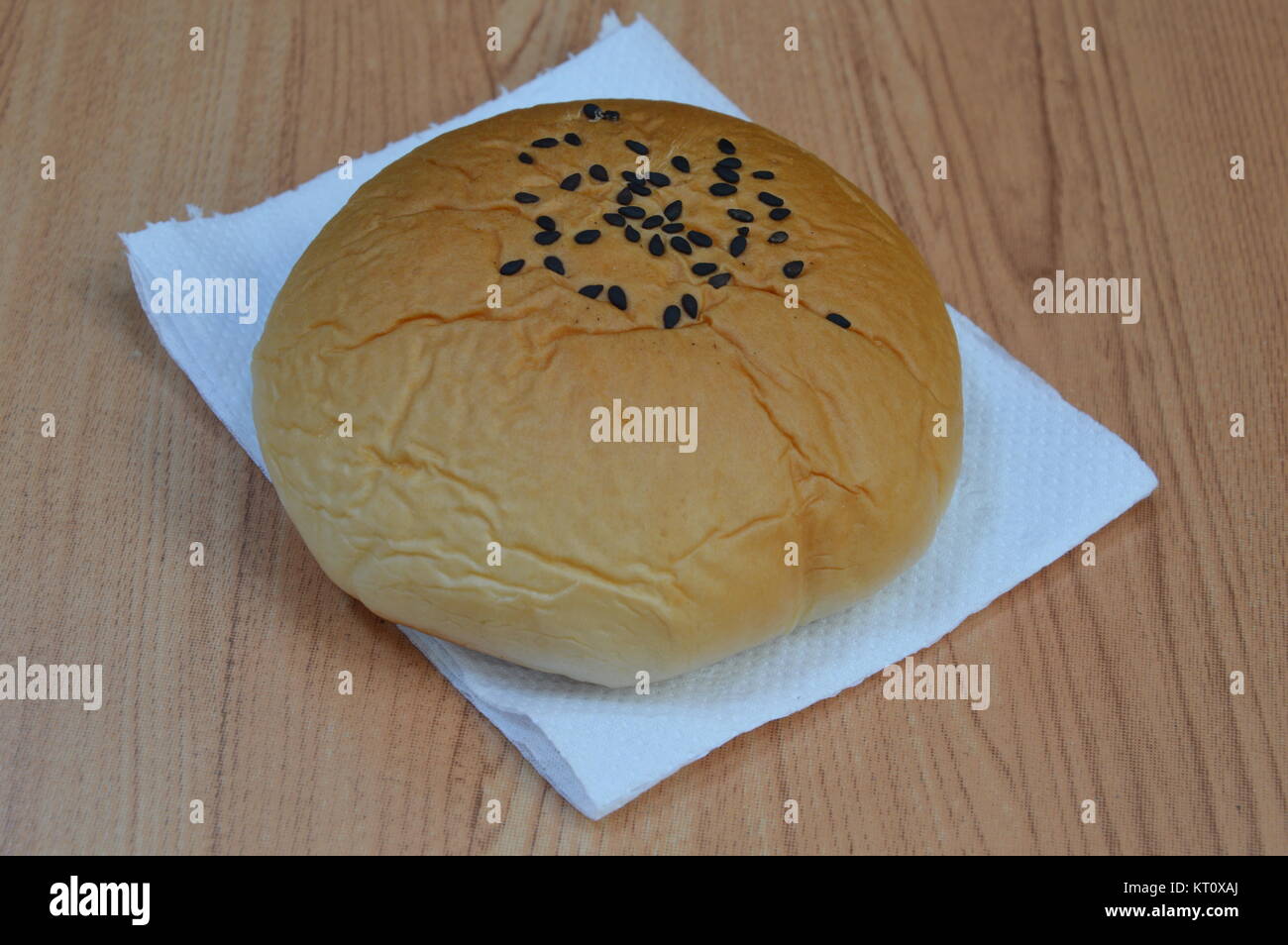 bun filling mashed red bean topping black sesame on paper Stock Photo ...