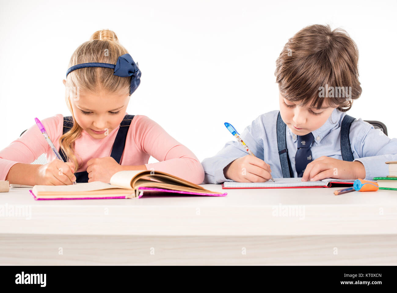 Classmates writing homework in notebooks Stock Photo - Alamy