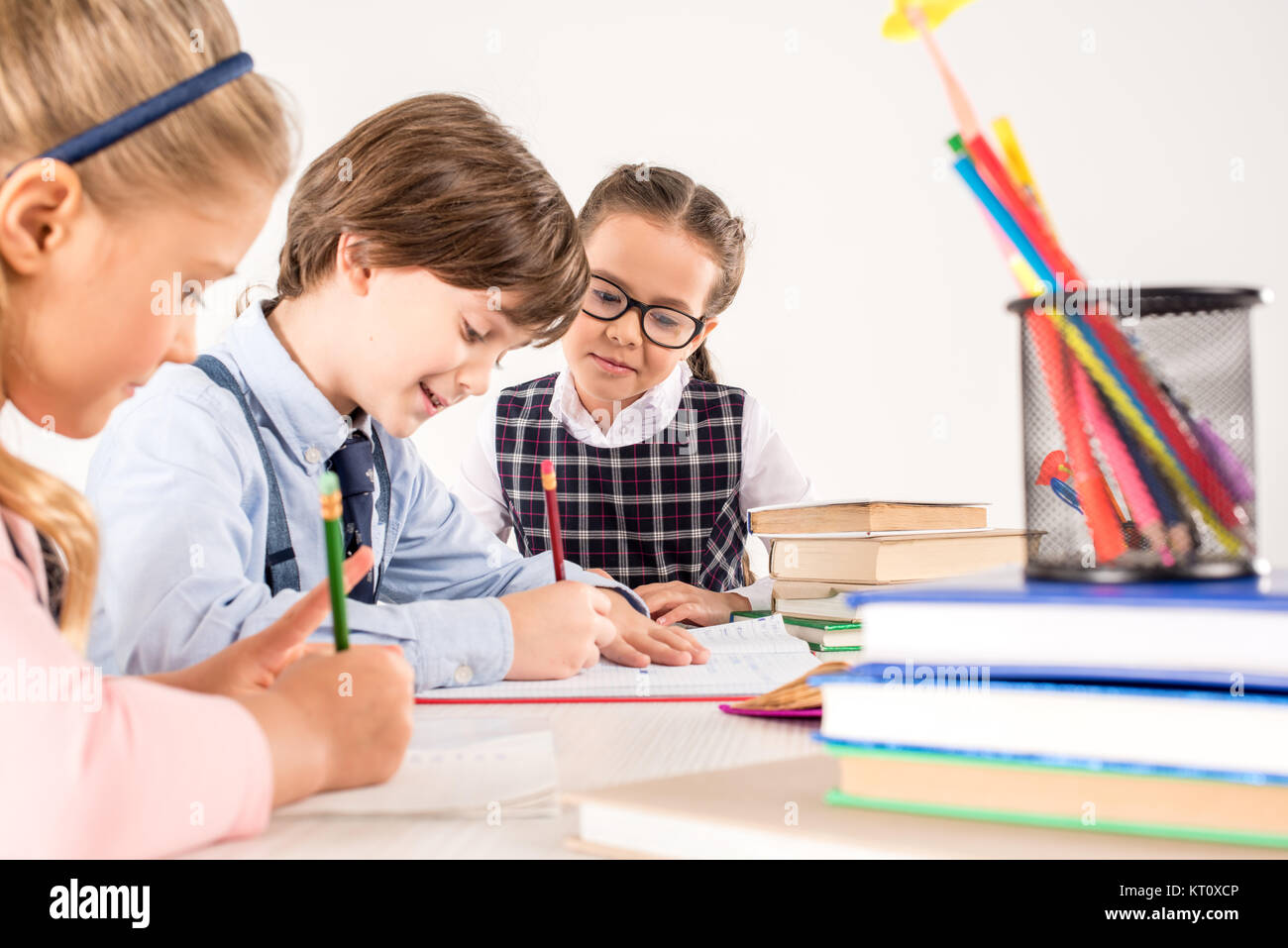 Children writing in notebooks Stock Photo - Alamy