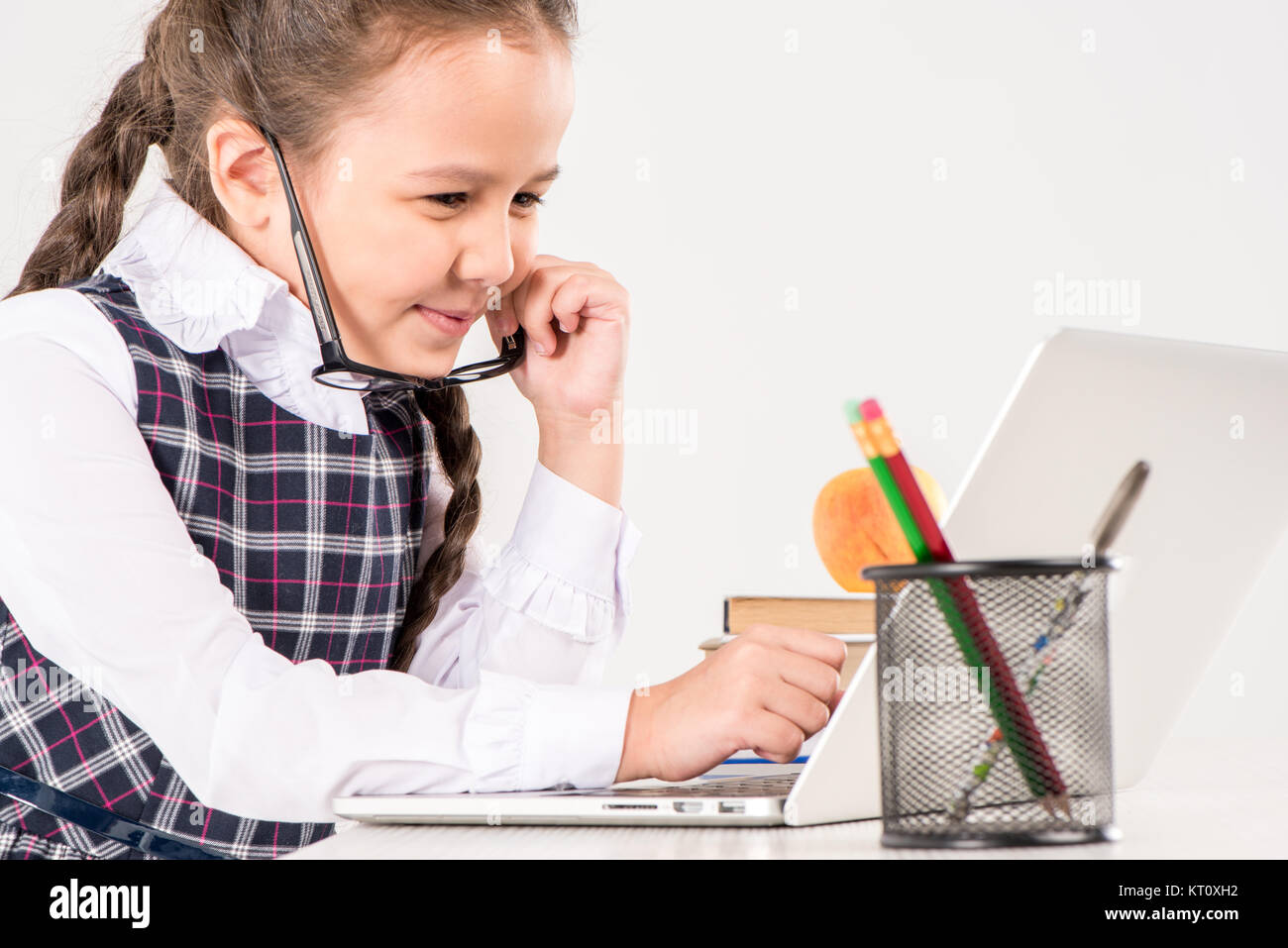 Schoolgirl at desk with laptop Stock Photo - Alamy