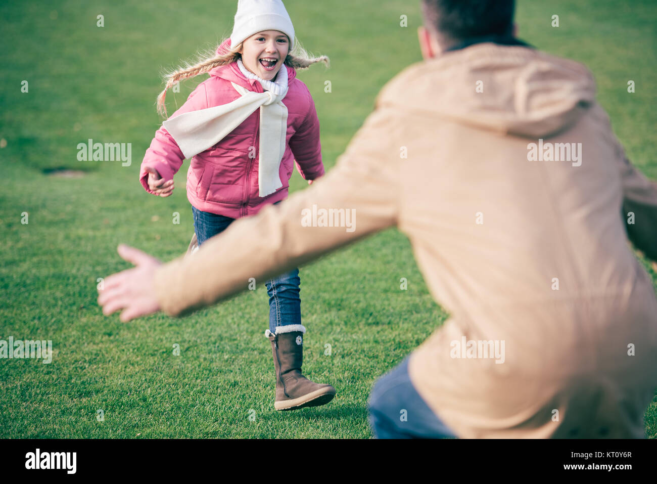 Adorable smiling girl running to father Stock Photo - Alamy