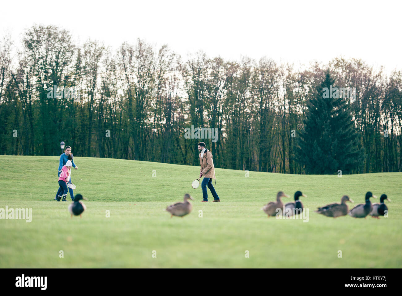 Happy family playing badminton Stock Photo - Alamy