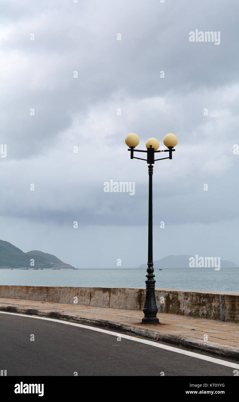 Lamp post on rural road at rainy day with seascape background Stock ...