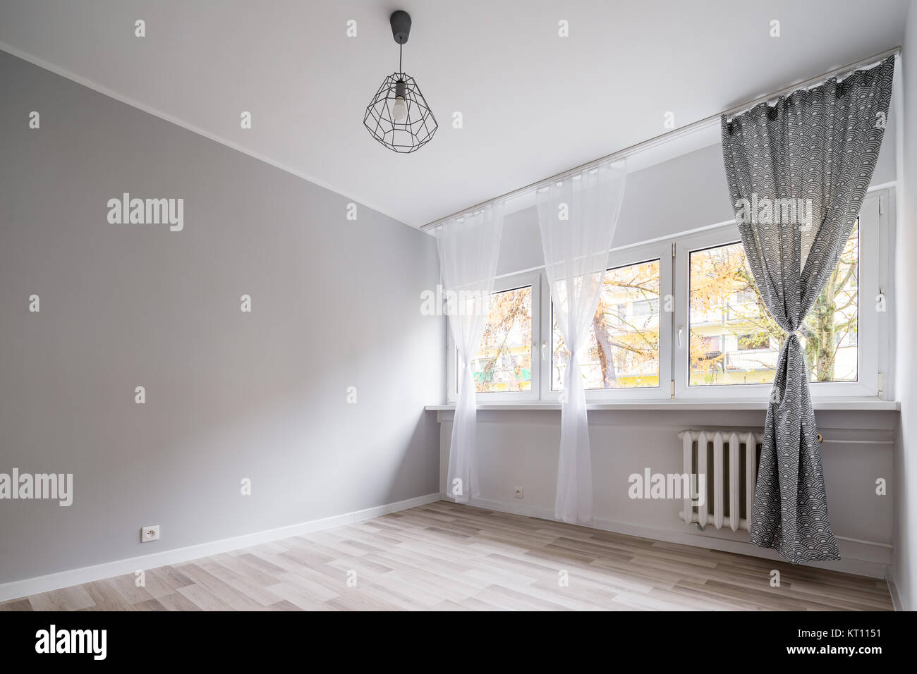 Empty modern room with patterned curtain and wire lampshade Stock Photo ...