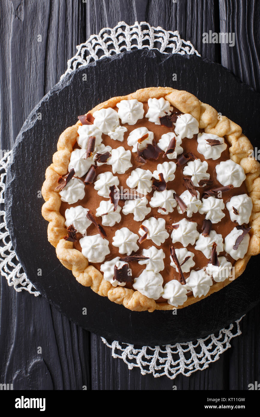 Homemade chocolate silk cake close-up on a table. vertical top view ...
