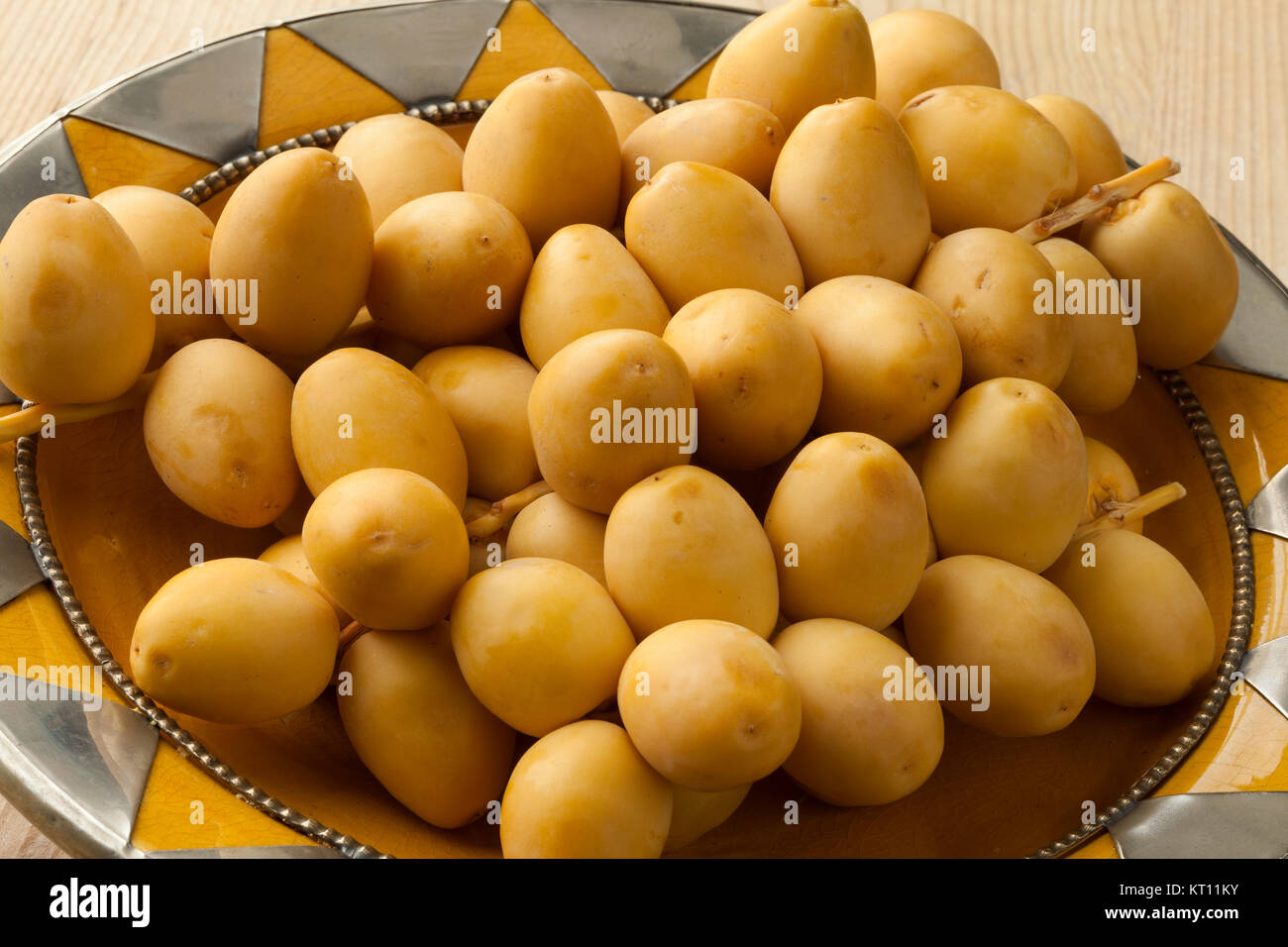Bunch of fresh yellow dates on a mediterranean dish Stock Photo - Alamy