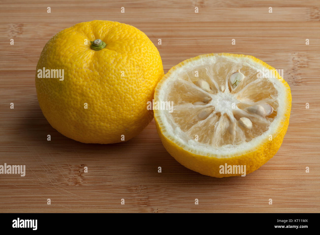 Fresh yellow whole and half Japanese Yuzu fruit Stock Photo - Alamy