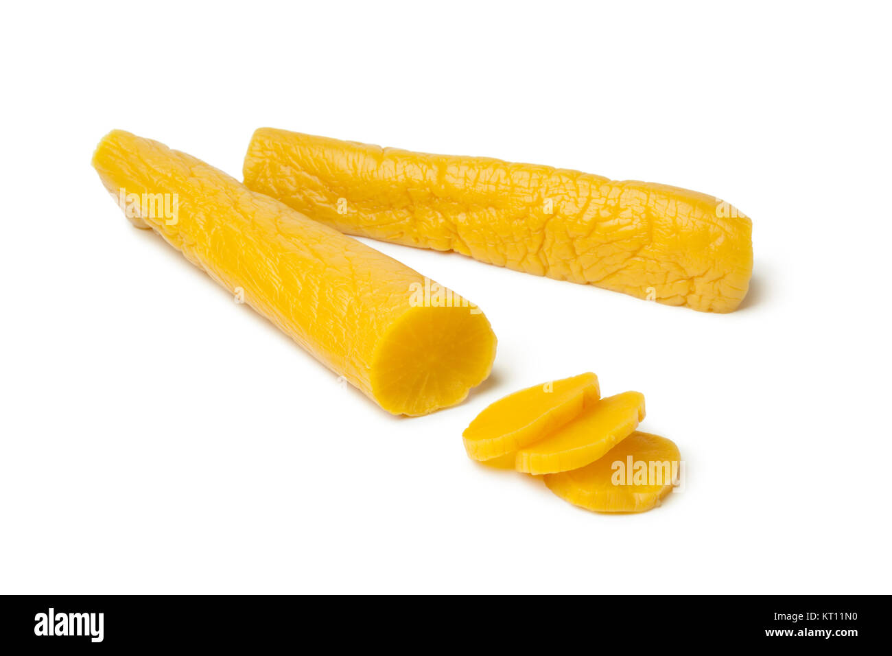 Traditional yellow Japanese pickled radish and slices on white ...