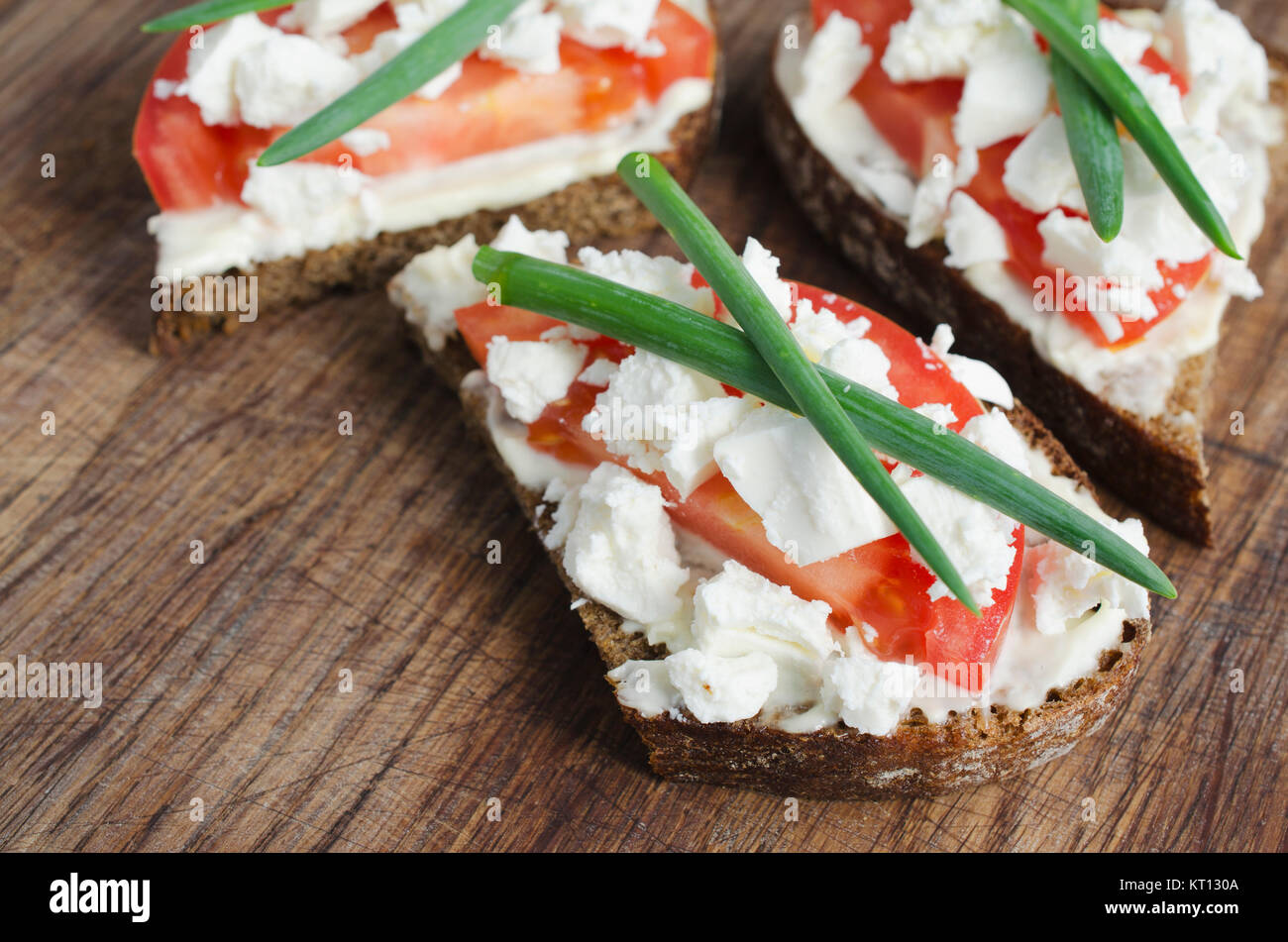 Slices of rye bread with sire feta and tomato Stock Photo - Alamy