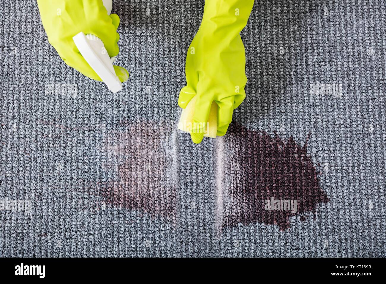 Woman Wiping Stains On The Carpet With Spray Bottle Stock Photo - Alamy