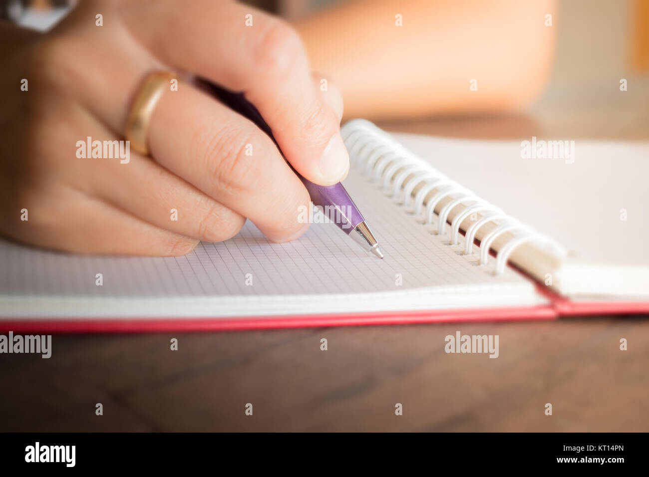 Woman hand writing on noteboook paper Stock Photo - Alamy