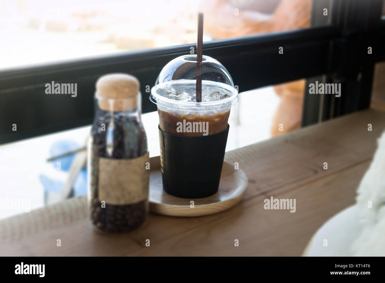 Iced coffee serving on wooden table Stock Photo - Alamy