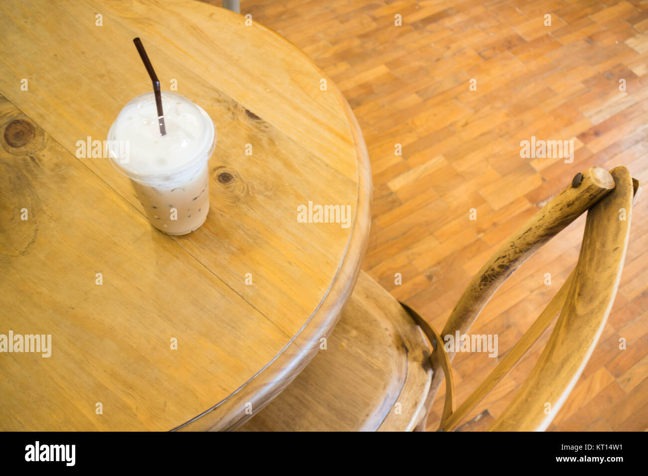 Iced coffee serving on wooden table Stock Photo - Alamy