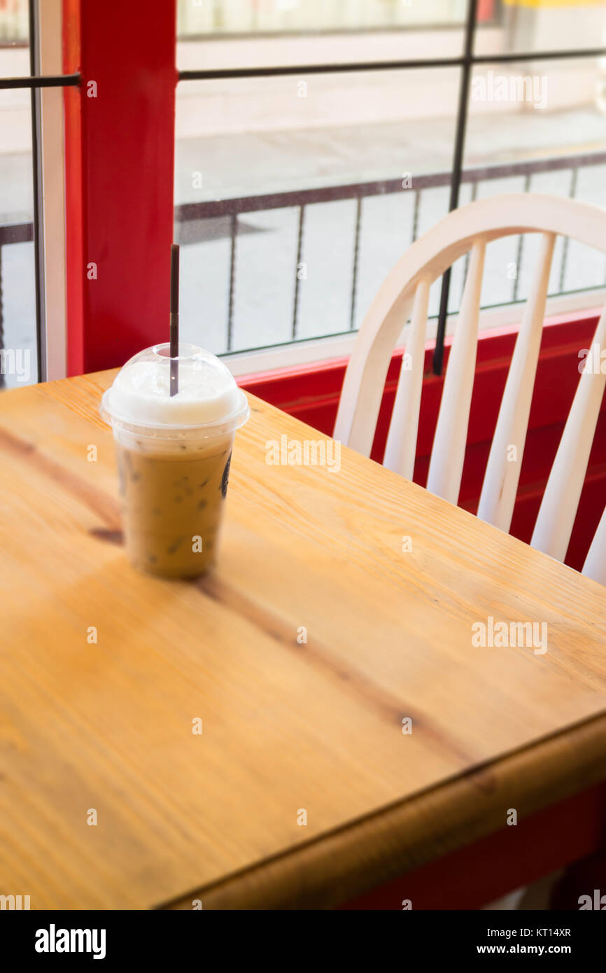 Iced coffee serving on wooden table Stock Photo - Alamy