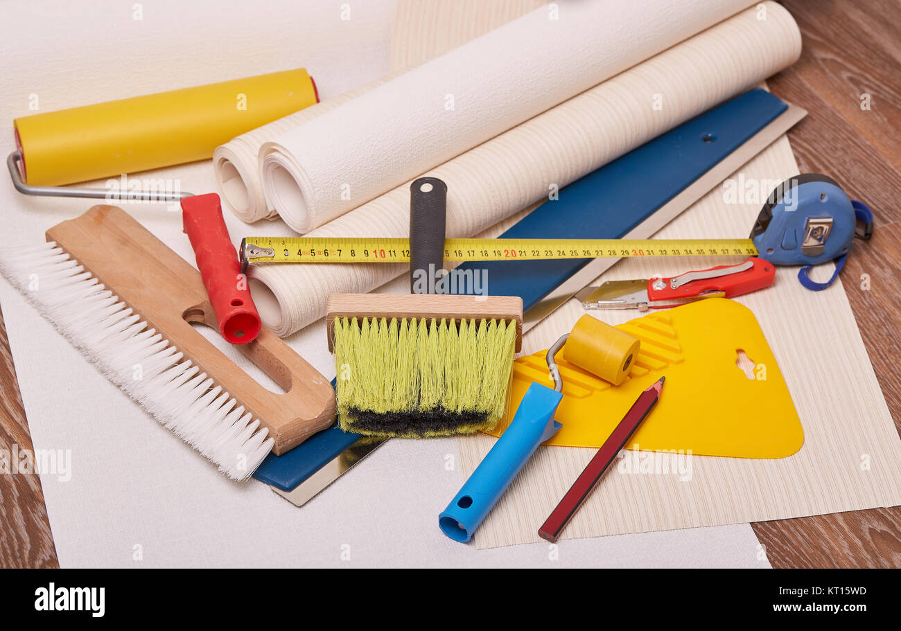 Rolls of wallpapers and various tools for wallpapering Stock Photo - Alamy