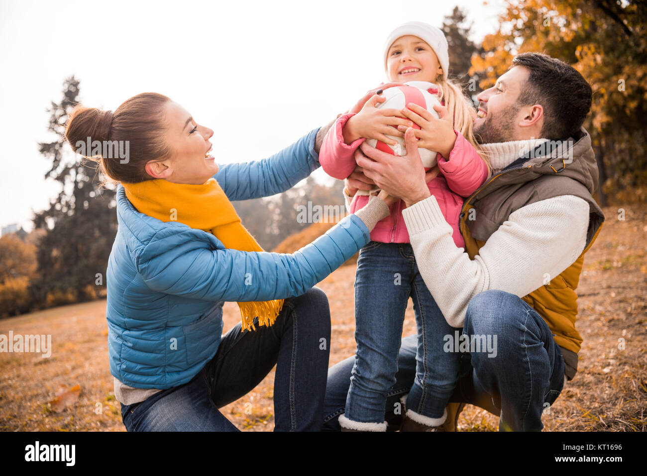 Happy family playing in park Stock Photo - Alamy