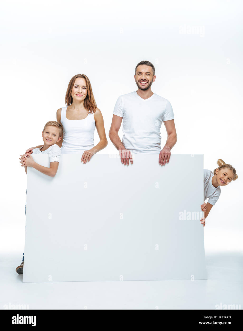 Happy family holding blank card Stock Photo - Alamy