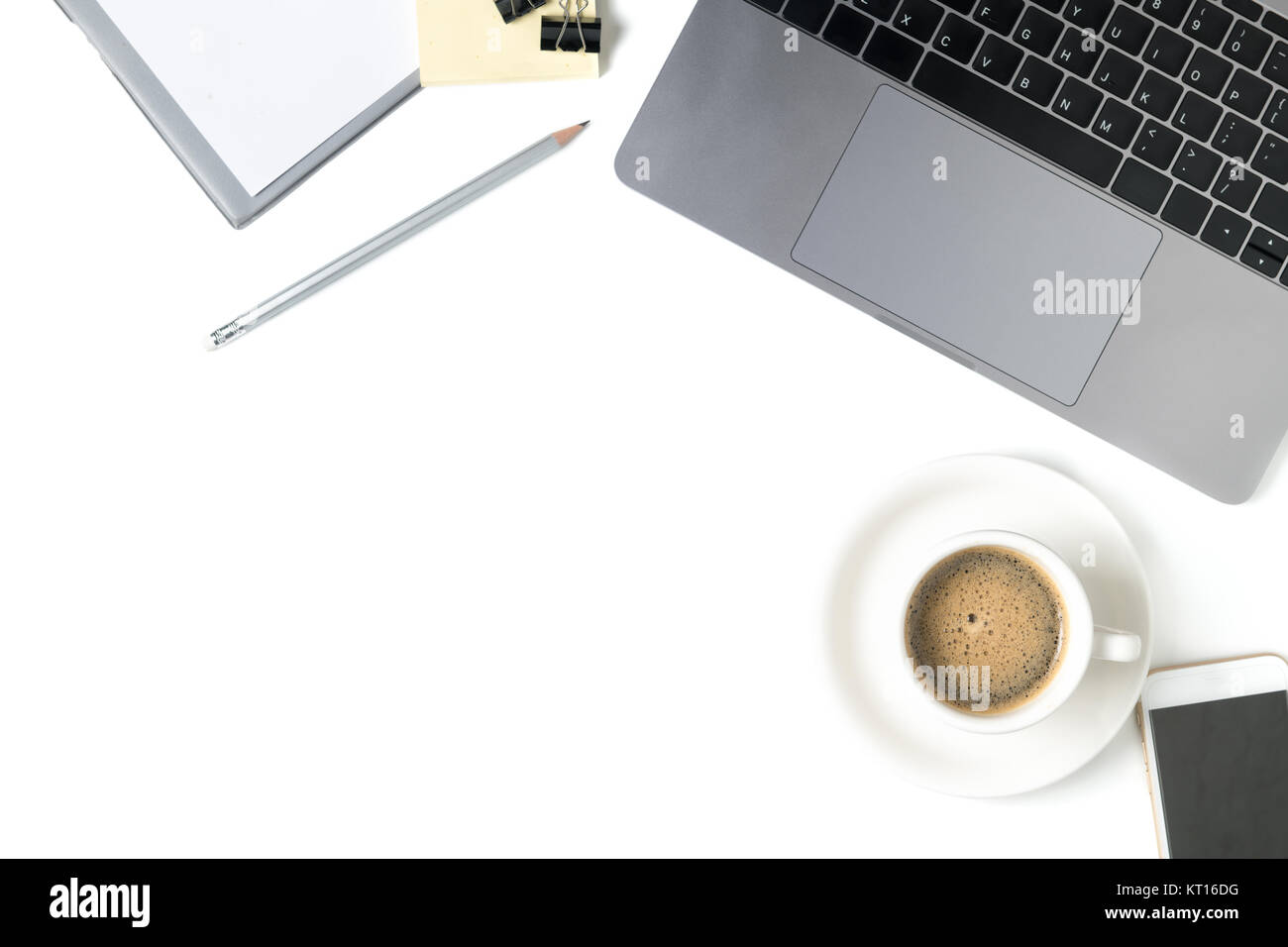 Desk with laptop, coffee, notebook and smart phone isolated on white ...
