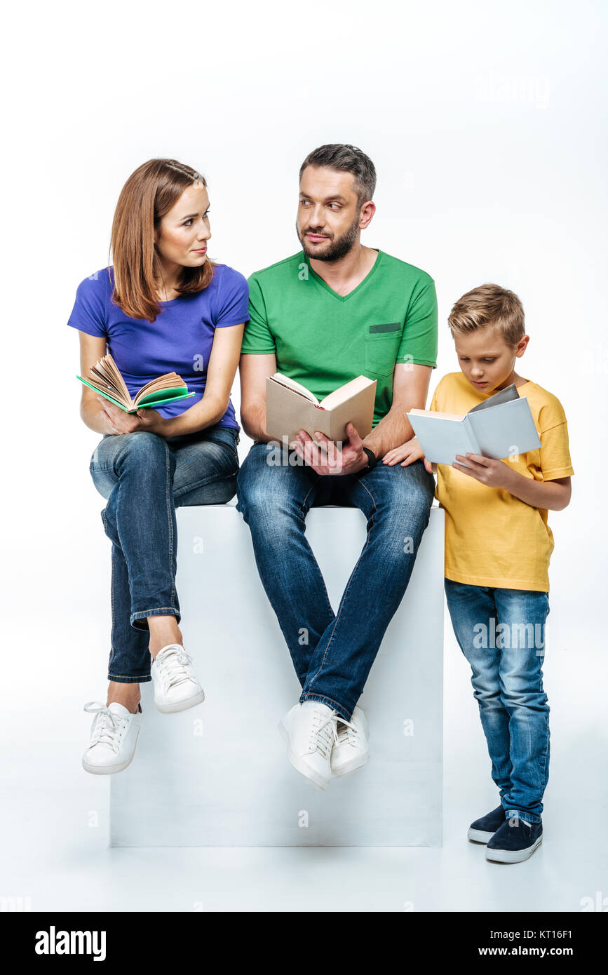family with one child reading books Stock Photo - Alamy