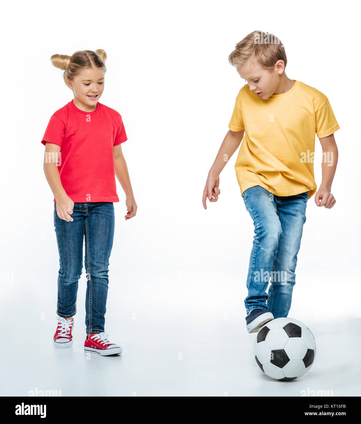 siblings playing with soccer ball Stock Photo - Alamy