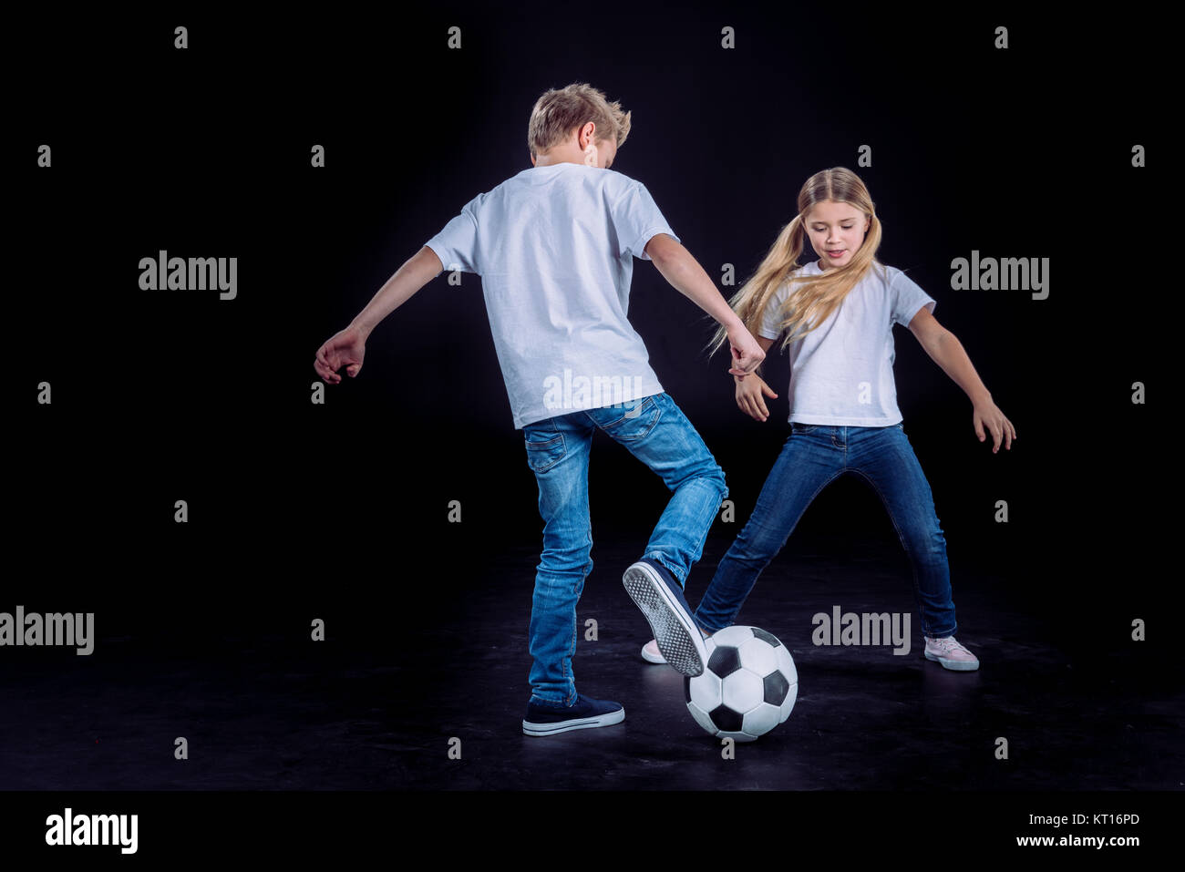 brother and sister playing with soccer ball Stock Photo - Alamy