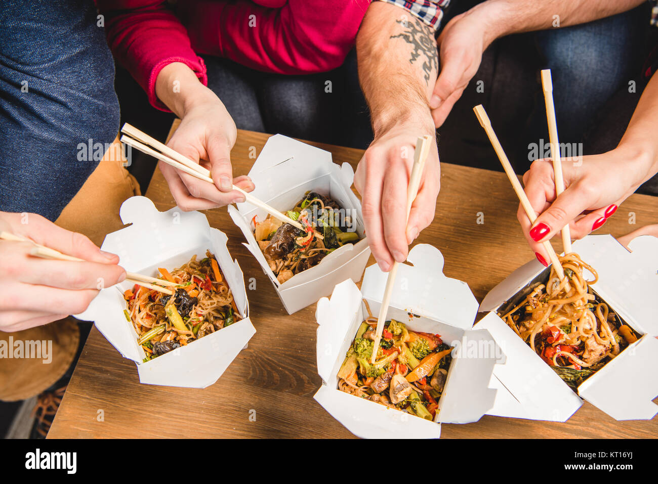 People eating noodles Stock Photo - Alamy