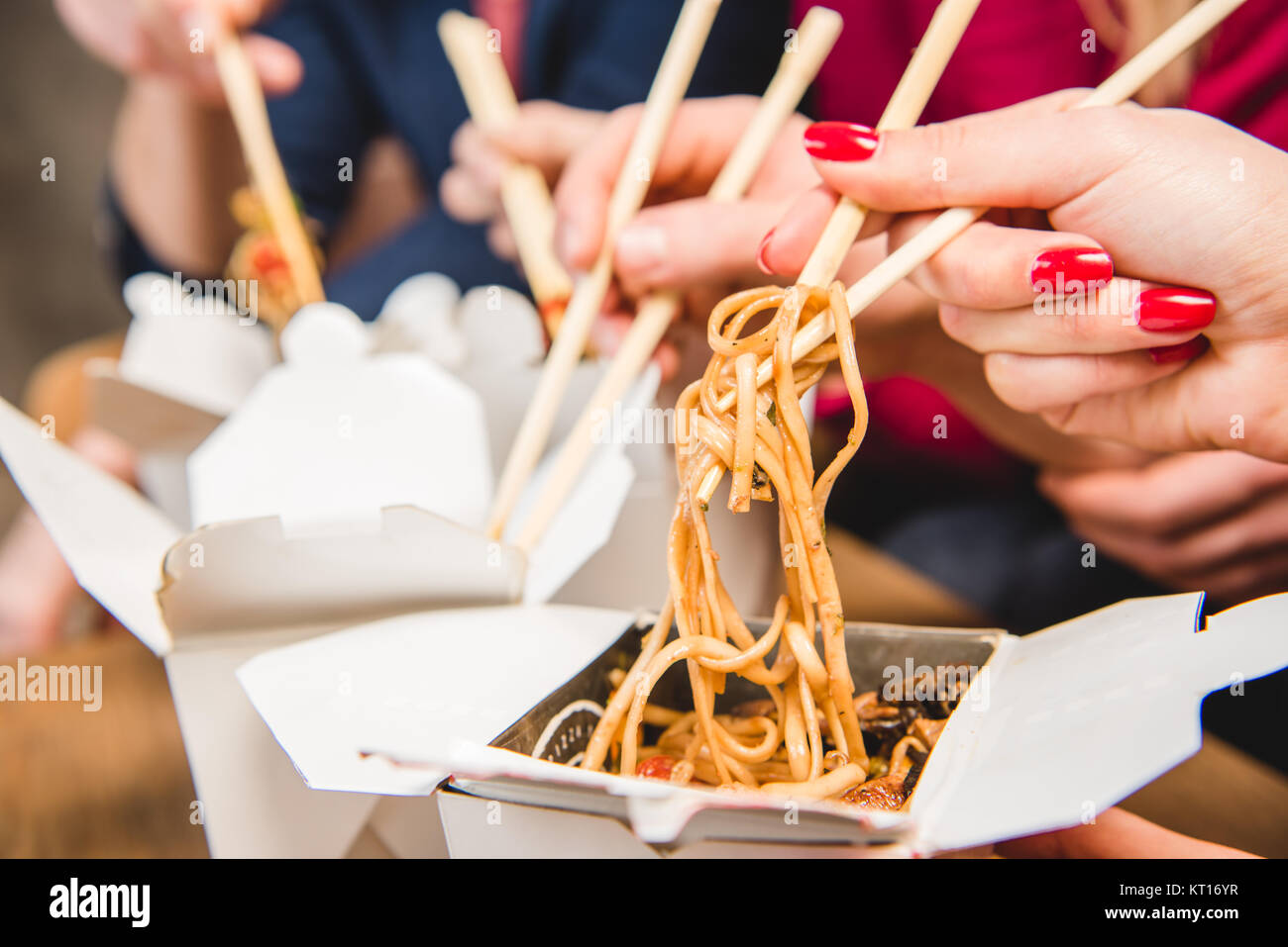 People eating noodles Stock Photo - Alamy