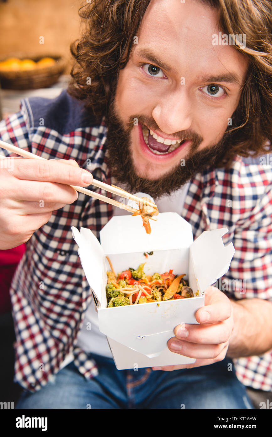 Man eating noodles Stock Photo - Alamy