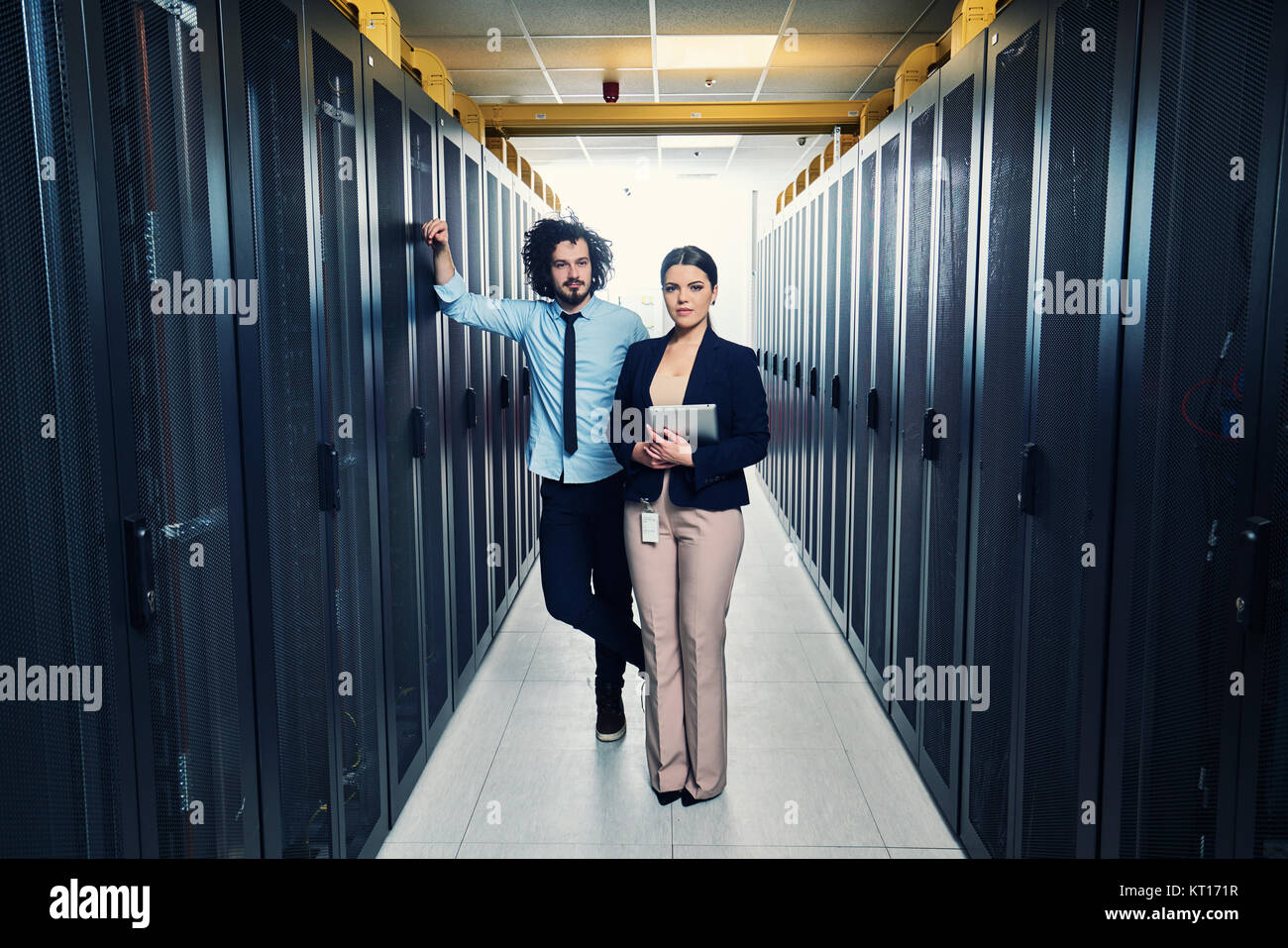 two young technicians working at a data center on server maintenance ...