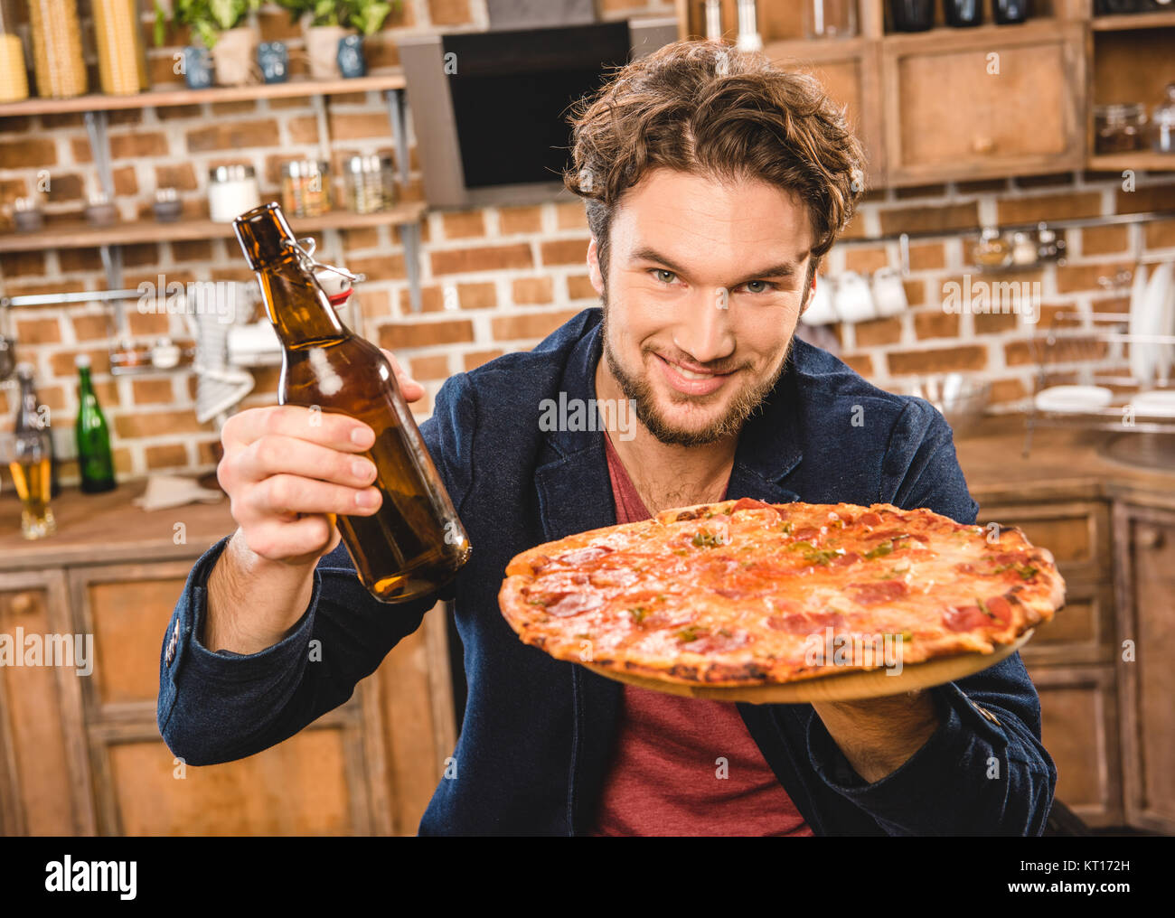 man with beer and pizza Stock Photo - Alamy