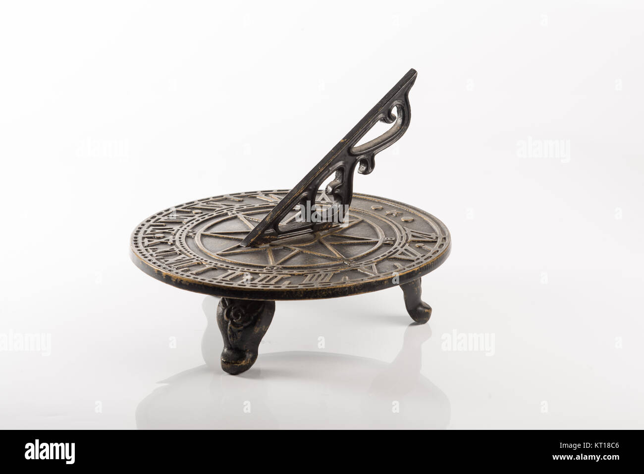 ancient bronze solar watch over a white background Stock Photo - Alamy