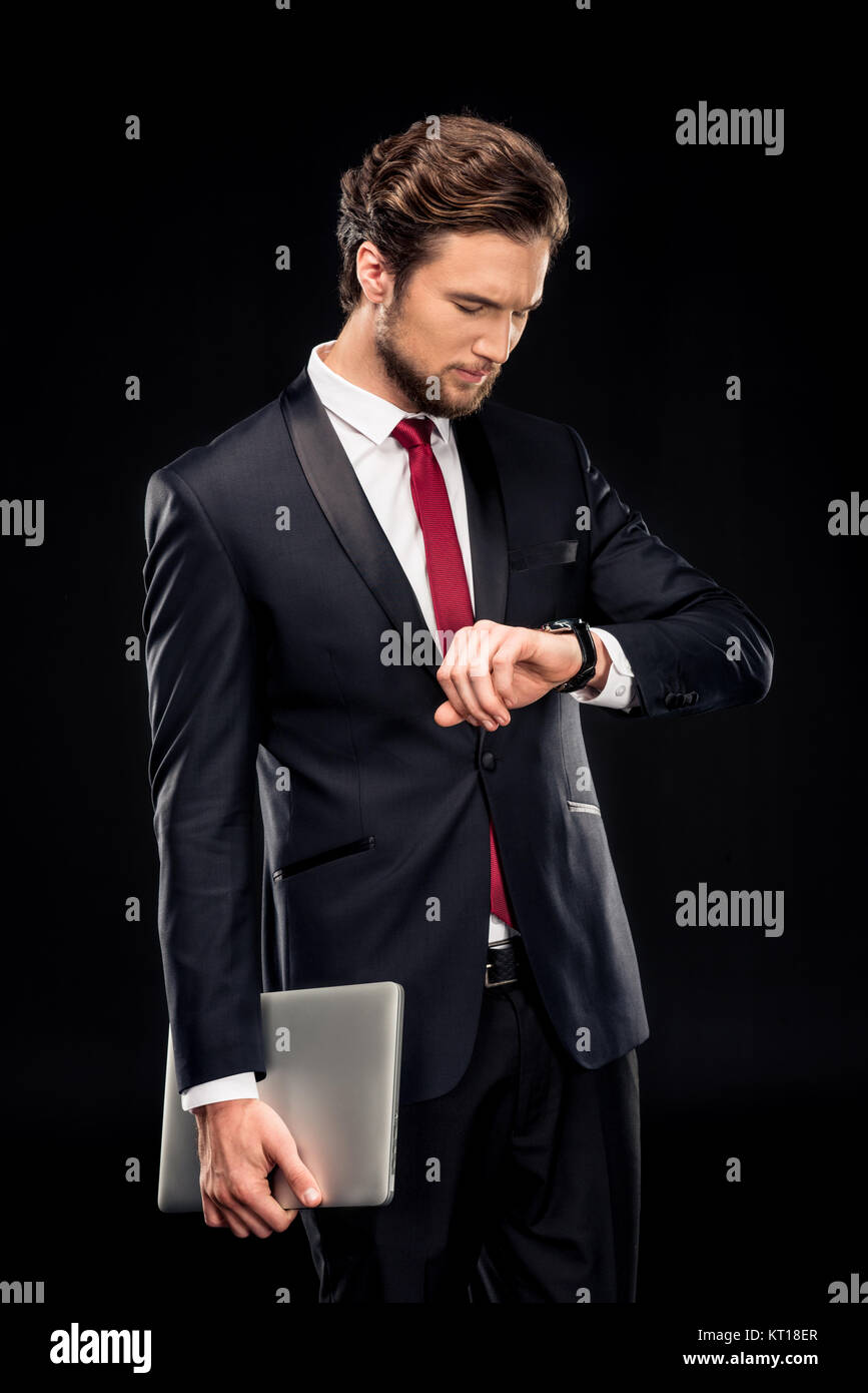Handsome businessman holding laptop Stock Photo - Alamy